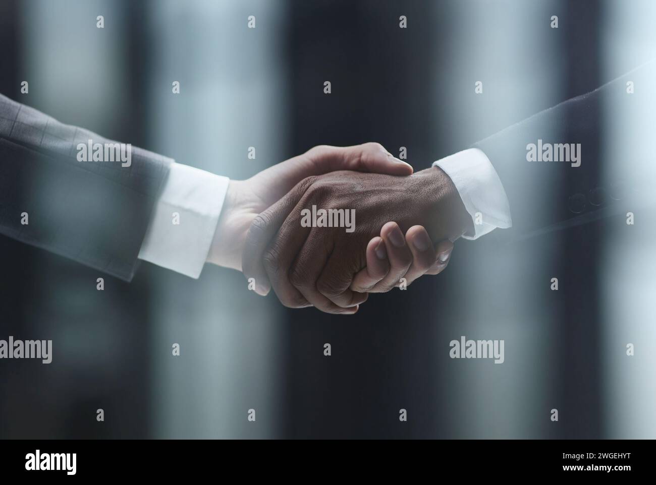 African man's hand shaking white man's hand on black background Stock ...