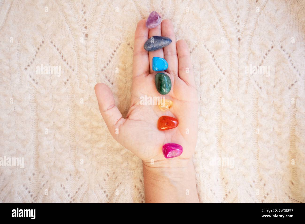 Healing crystals on female hand background, seven chakra stones Stock ...
