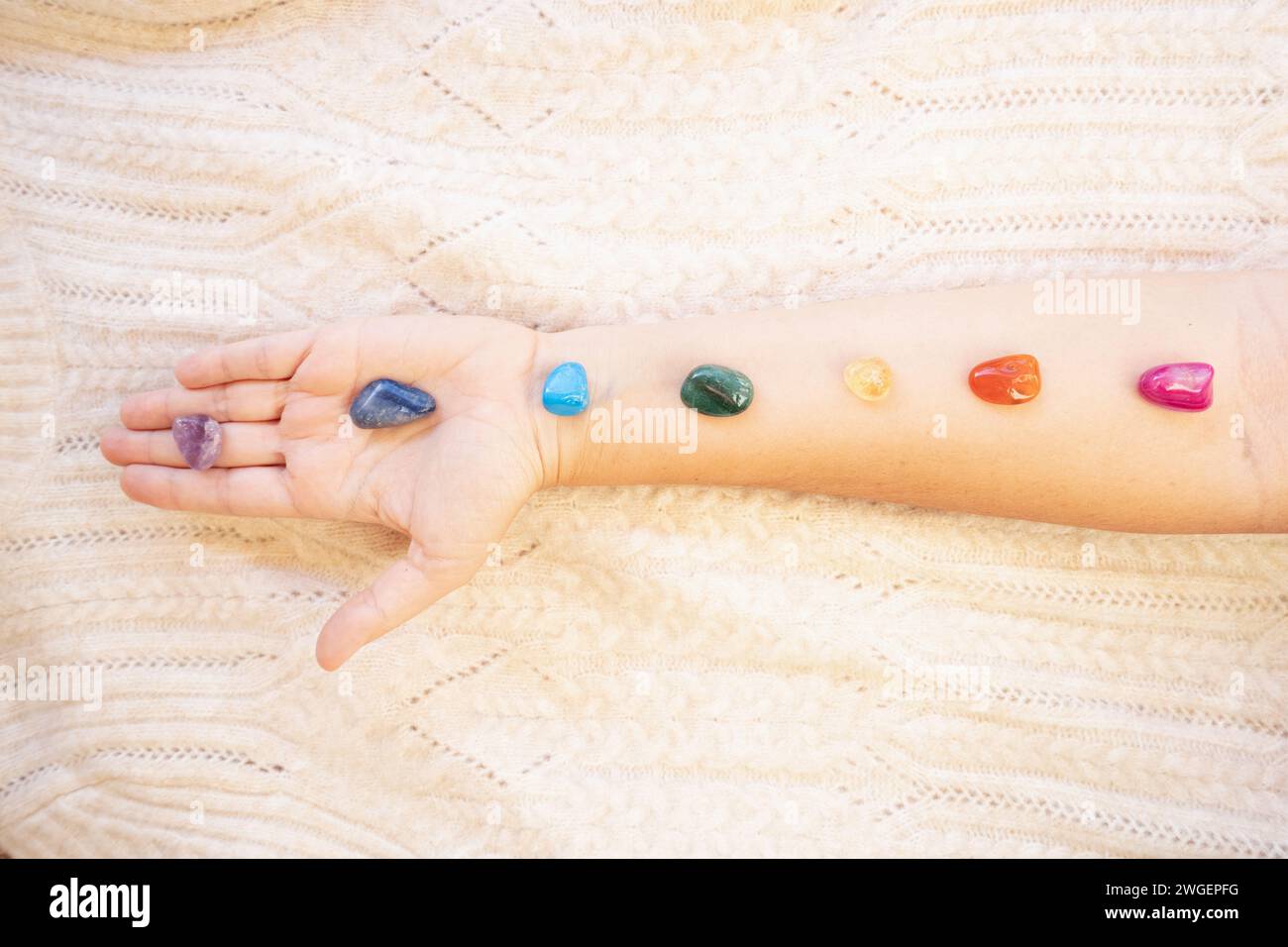 Healing crystals on female hand background, seven chakra stones Stock ...