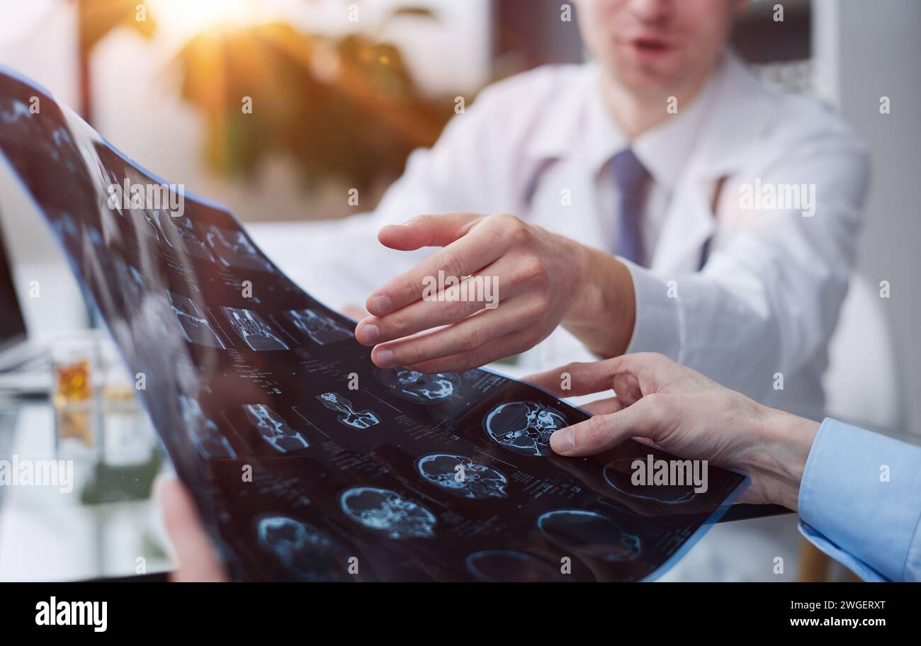 shows the x-ray image to the patient at the reception Stock Photo - Alamy