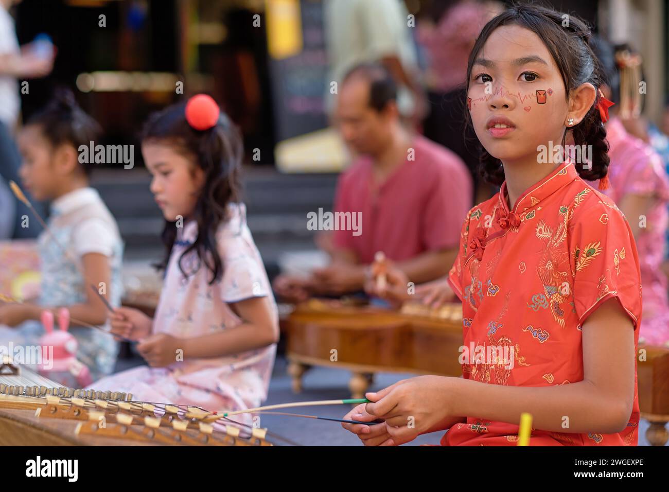 Thai children playing classical Thai music, lead by 3 young girls ...
