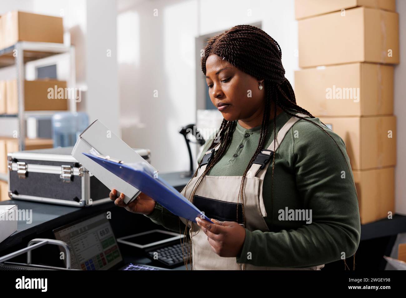 Small business worker analyzing merchandise logistics, checking ...