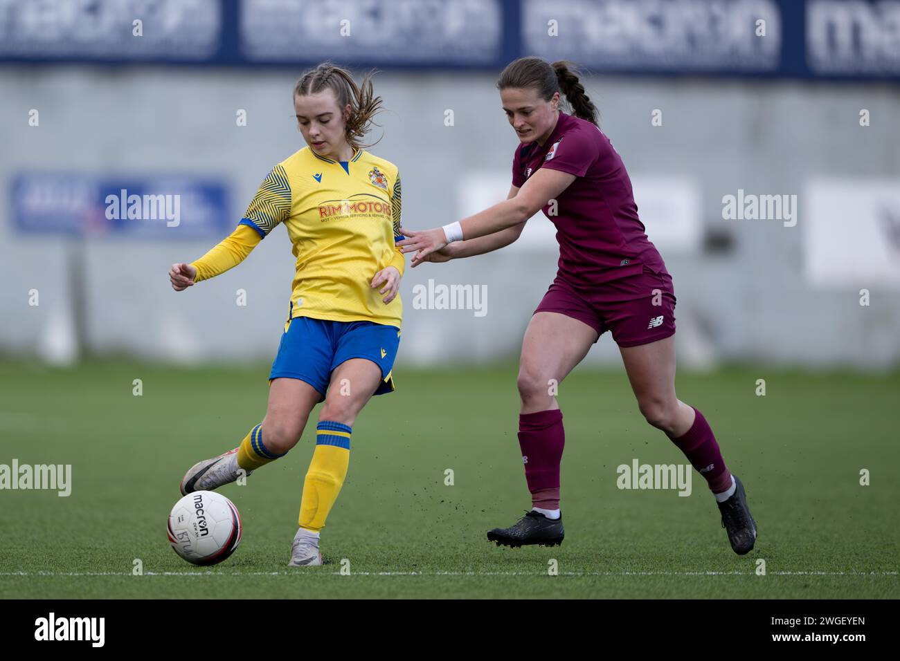 Barry, UK. 4th February 2024. Sienna Stone of Barry Town United battles for the ball with Ffion ...