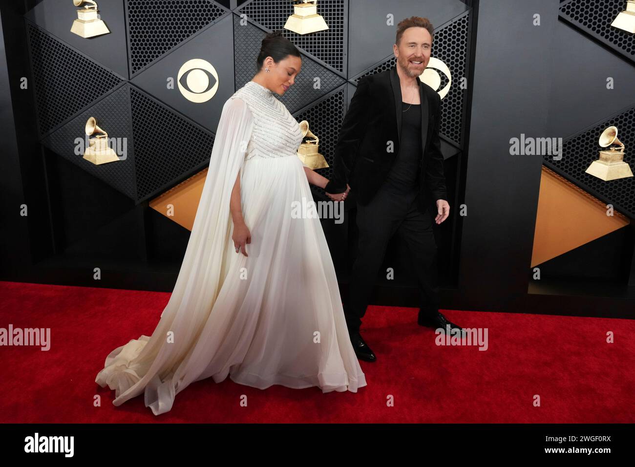 Jessica Ledon, left, and David Guetta arrive at the 66th annual Grammy ...