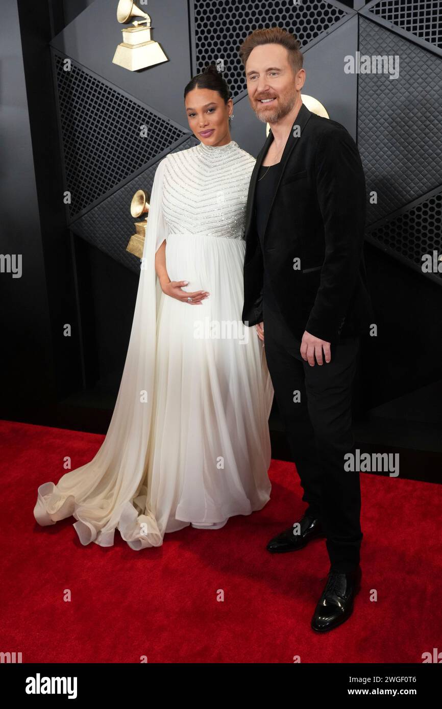 Jessica Ledon, left, and David Guetta arrive at the 66th annual Grammy ...