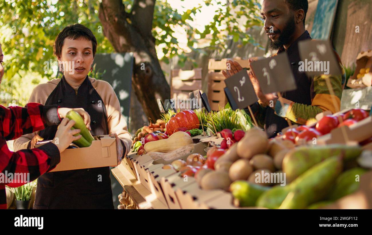 Senior man and young woman buying organic bio products, visiting local ...