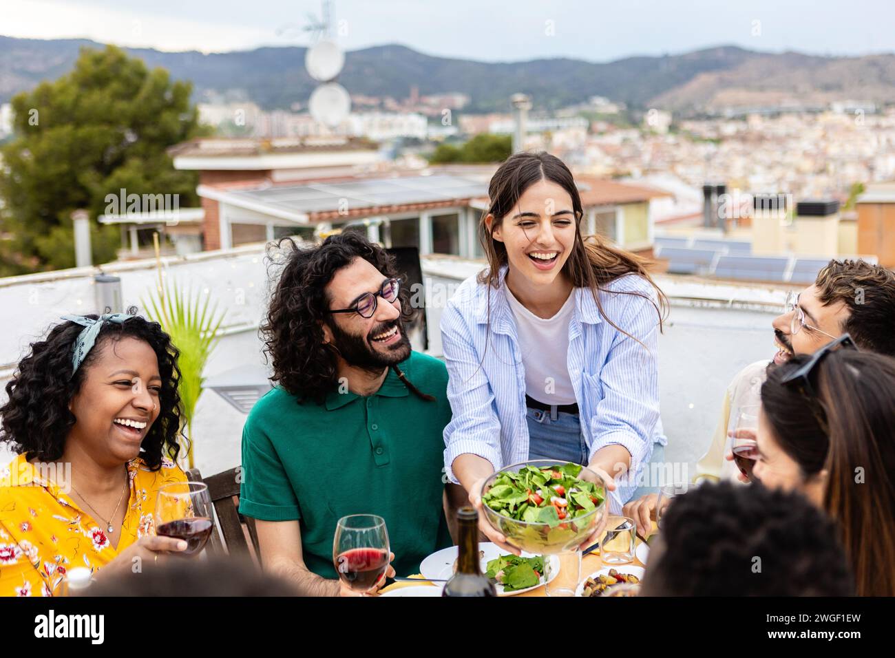 Group of diverse friends enjoying dinner eating in a terrace Stock ...