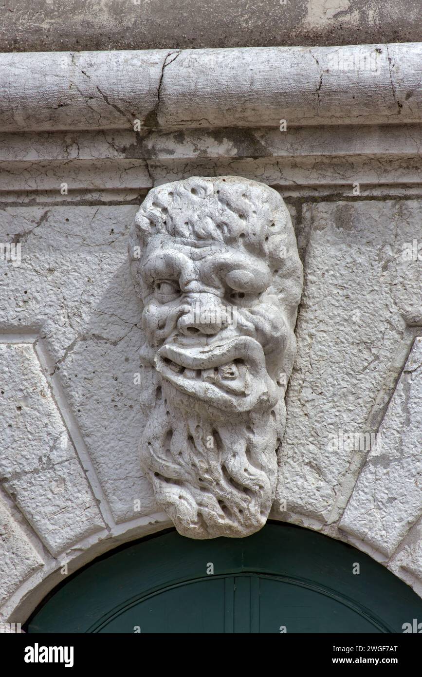Grotesque Mask on house facade in Venice Italy Stock Photo - Alamy