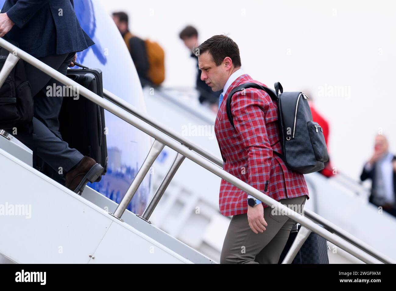 Kansas City Chiefs general manager Brett Veach boards a plane with the ...
