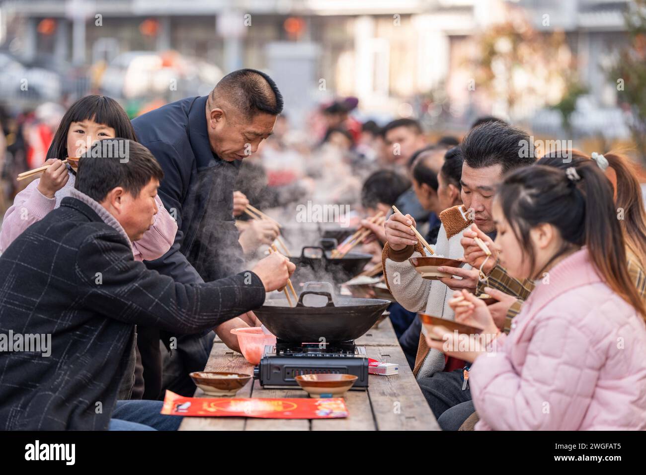 BIJIE, CHINA - FEBRUARY 4, 2024 - People eat a long table banquet at ...