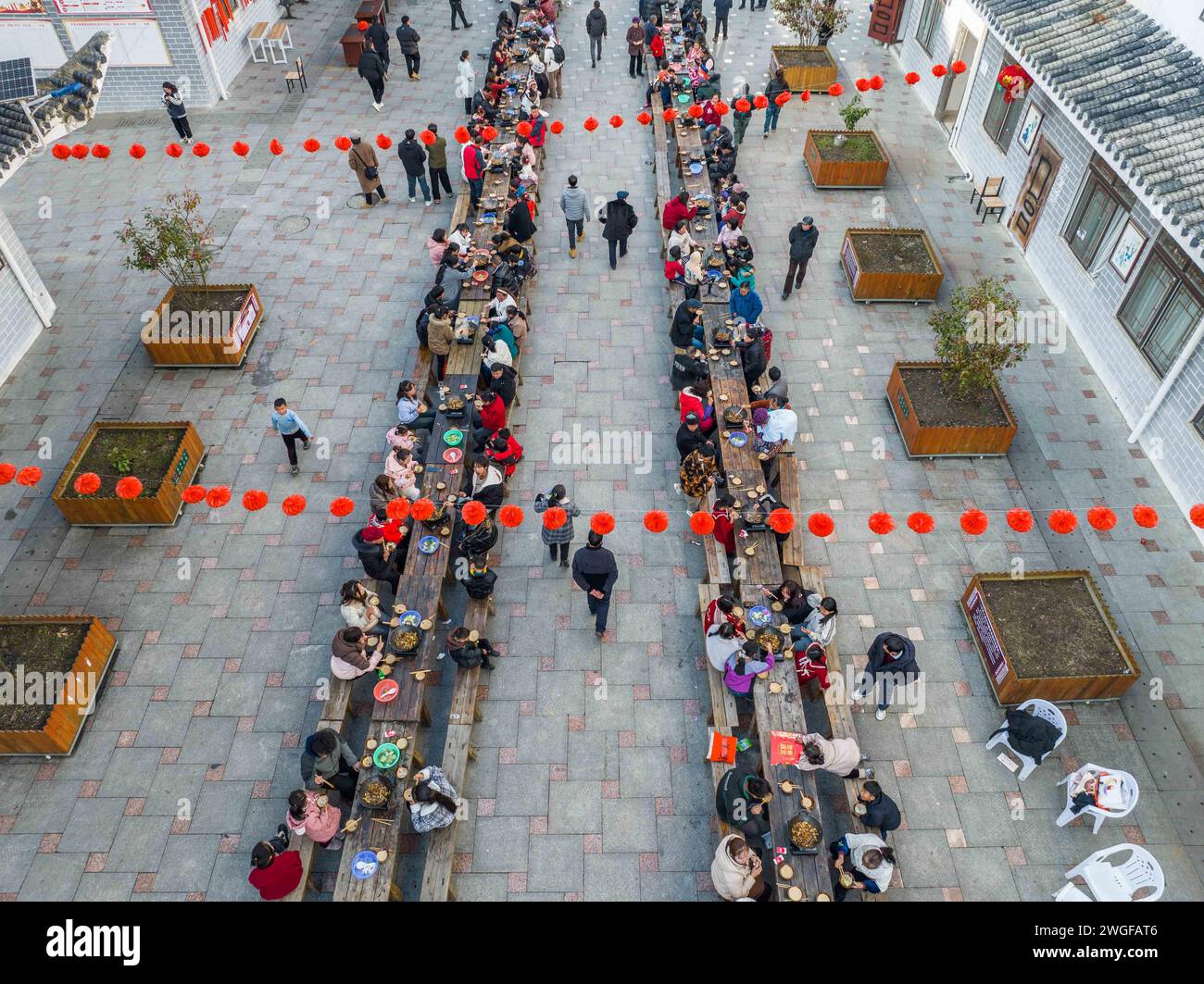 BIJIE, CHINA - FEBRUARY 4, 2024 - People eat a long table banquet at ...