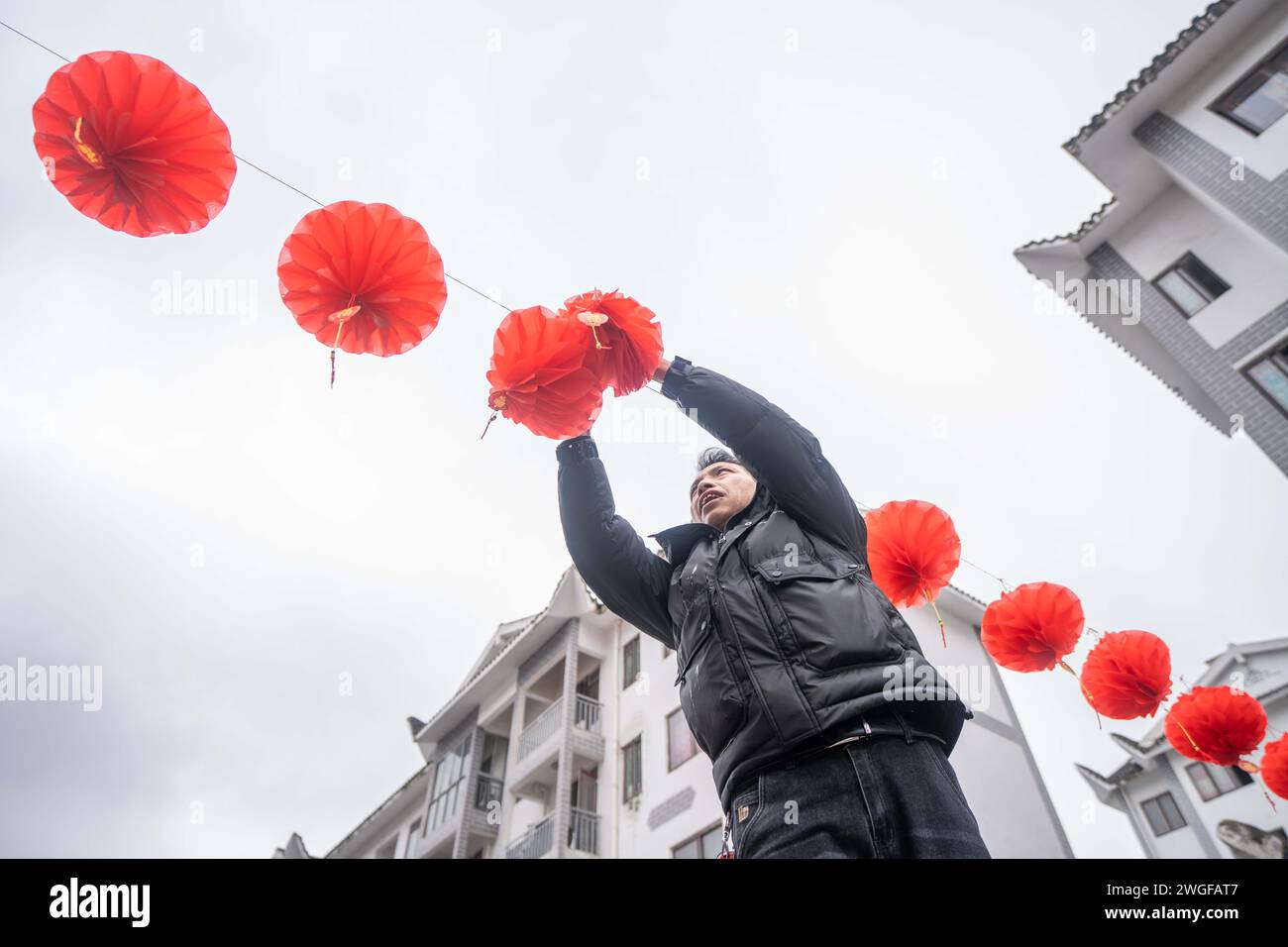 BIJIE, CHINA - FEBRUARY 4, 2024 - People hang red lanterns at Pingzi ...