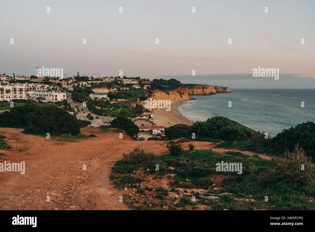 Picturesque sunset over cliffs and the ocean, with the silhouette of a ...