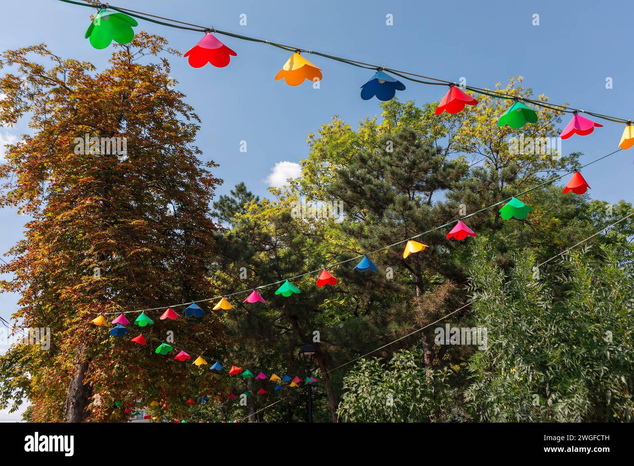 Colorful garlands on a rope in the park, city celebration decor Stock ...