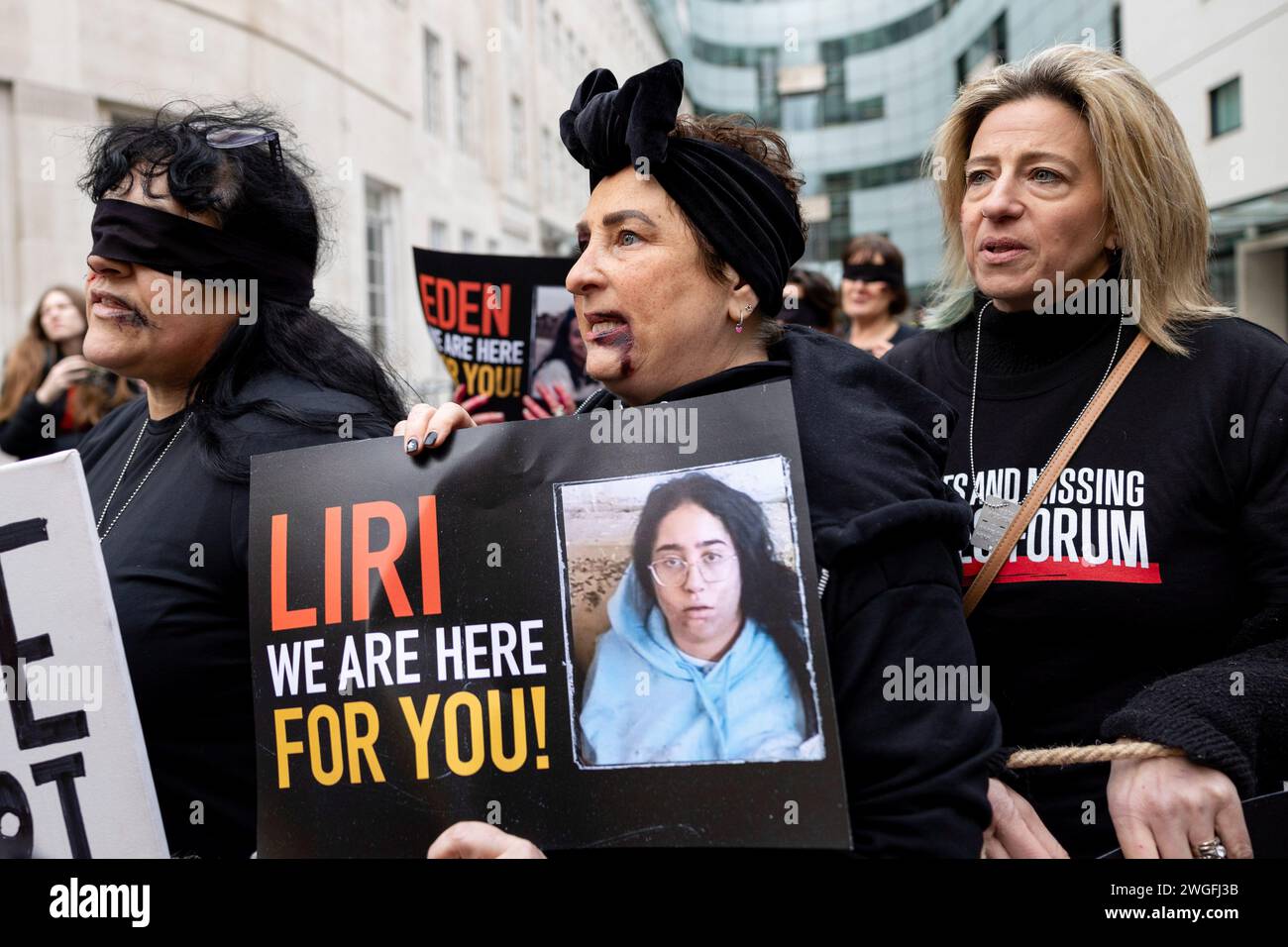 Female protesters cover their eyes and wear artificial wounds make-up ...