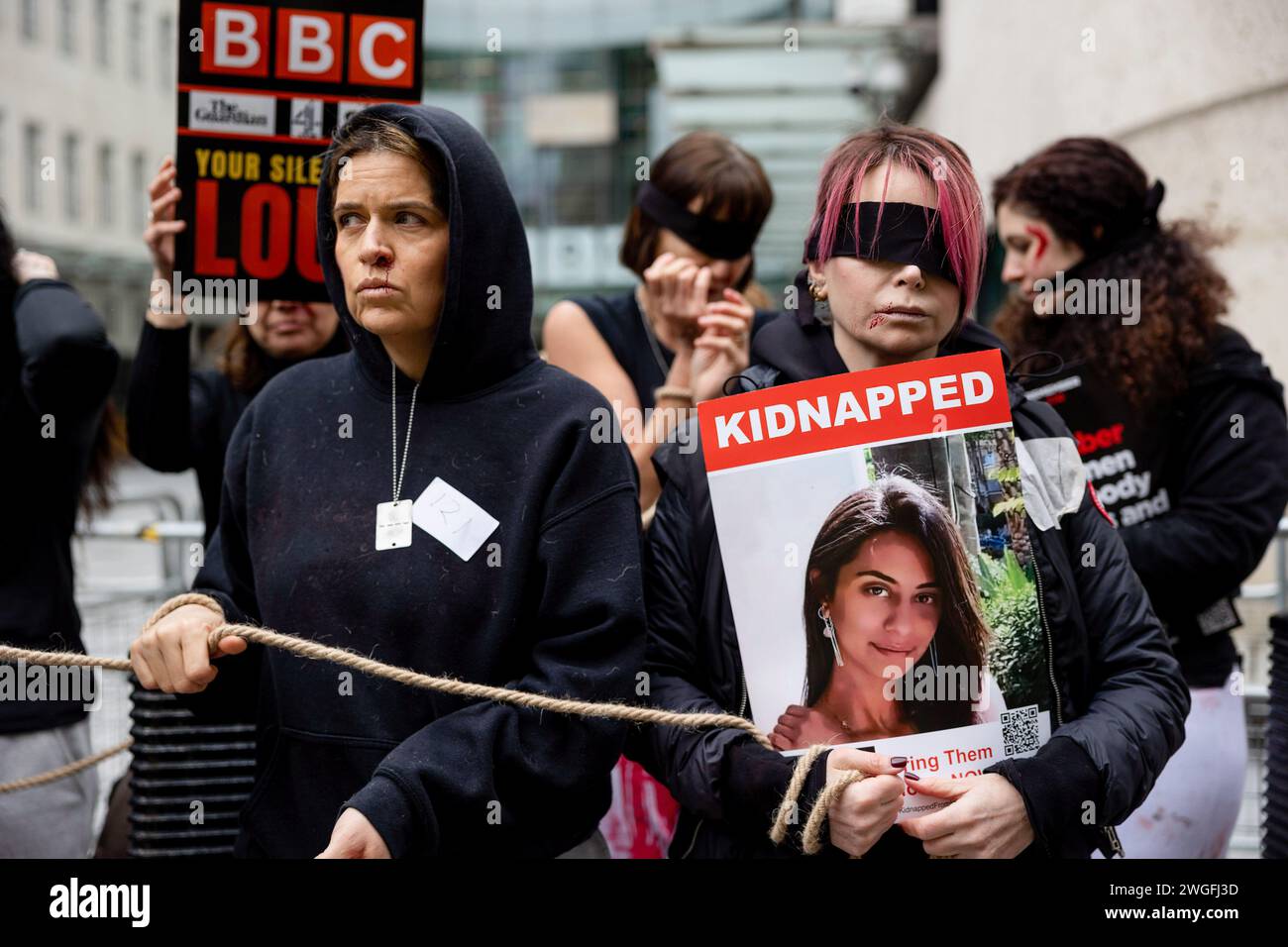 Female protesters cover their eyes and wear artificial wounds make-up ...