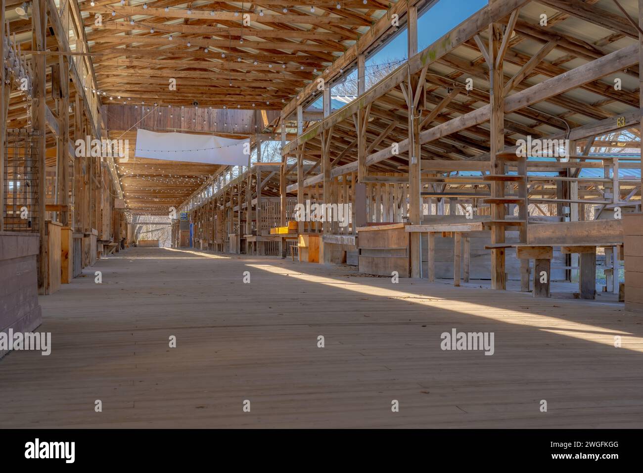 Empty open air farmers market wooden stalls within a pavilion on a ...
