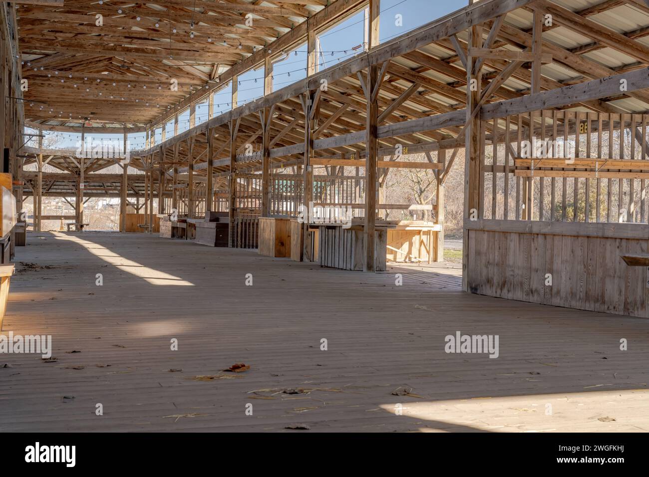 Empty open air farmers market wooden stalls within a pavilion on a ...