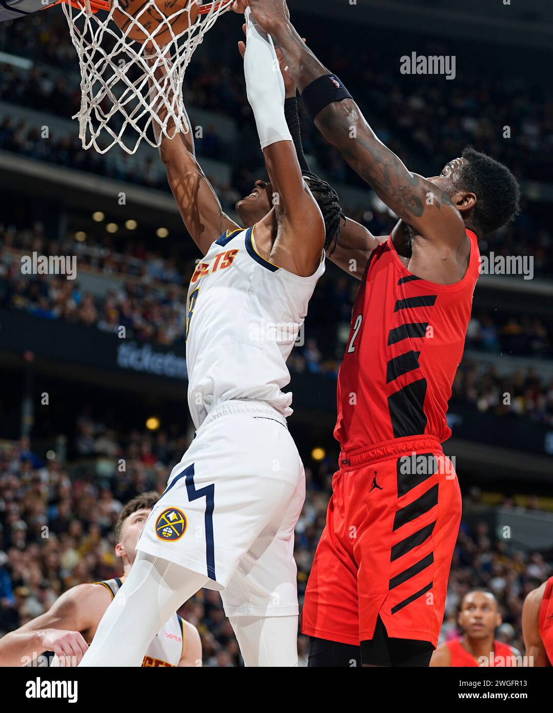 Denver Nuggets forward Peyton Watson, top left, dunks as Portland Trail ...