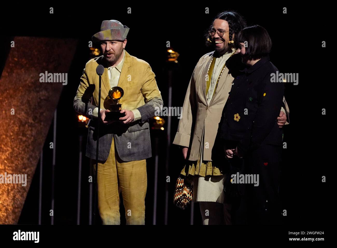 James Theseus Buck, from left, Luke Brooks, and Annie Collinge accept ...