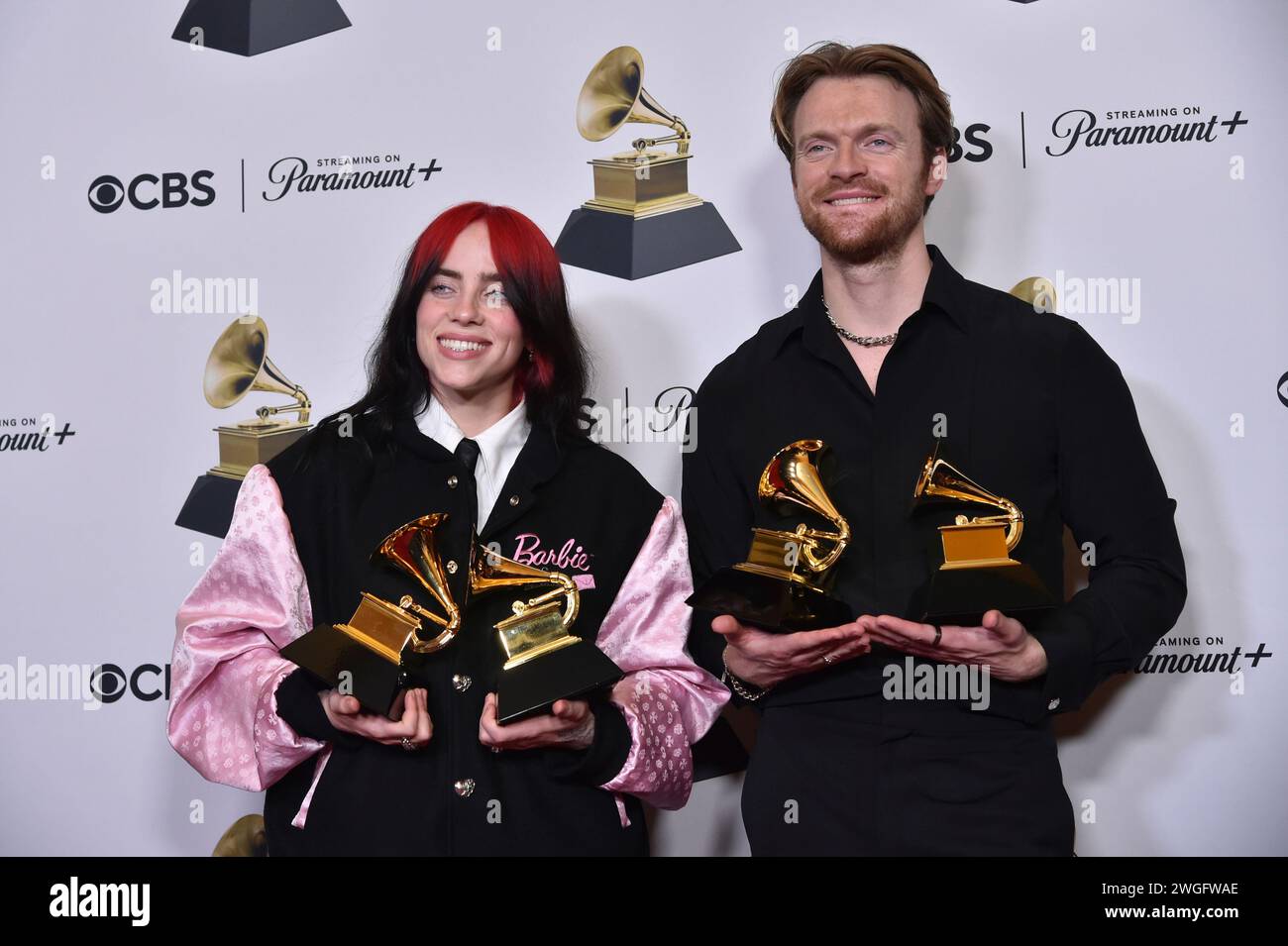 Billie Eilish, left, and Finneas pose in the press room with the awards ...