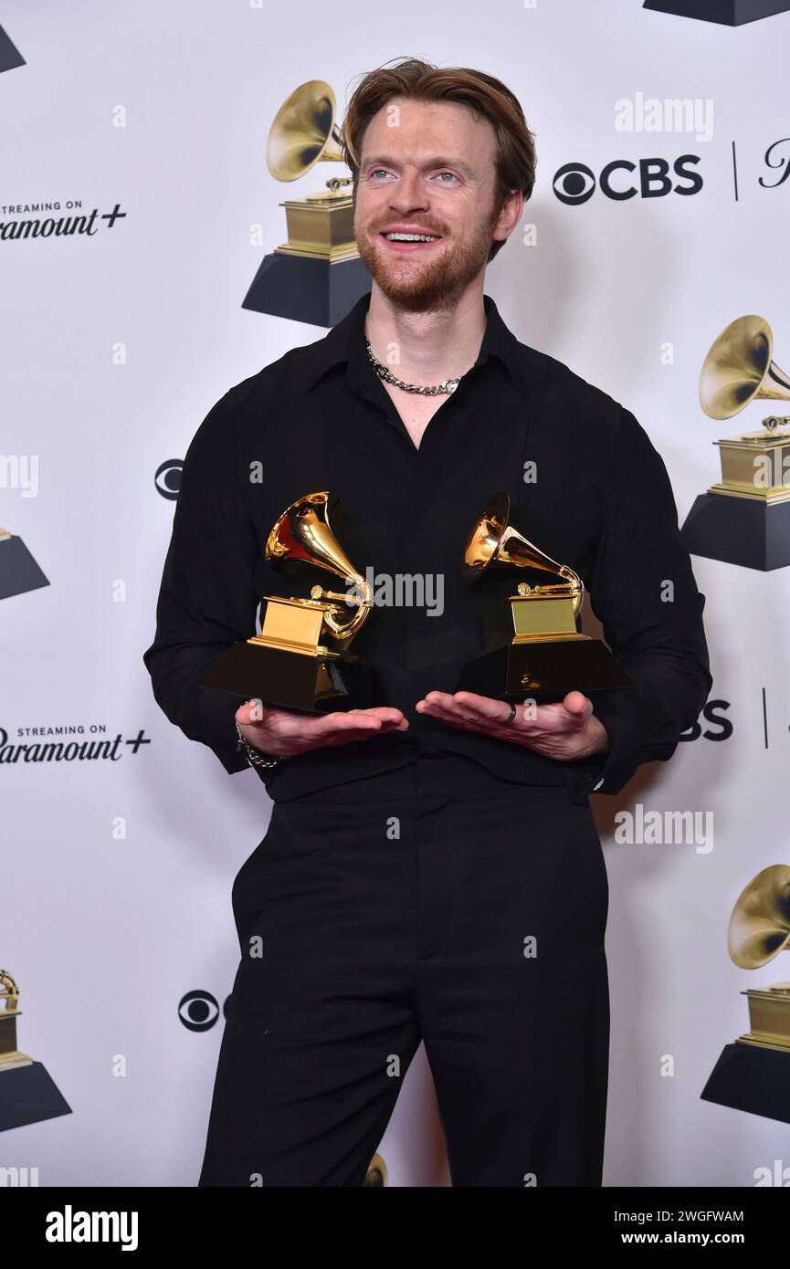 Finneas poses in the press room with the awards for best song written ...