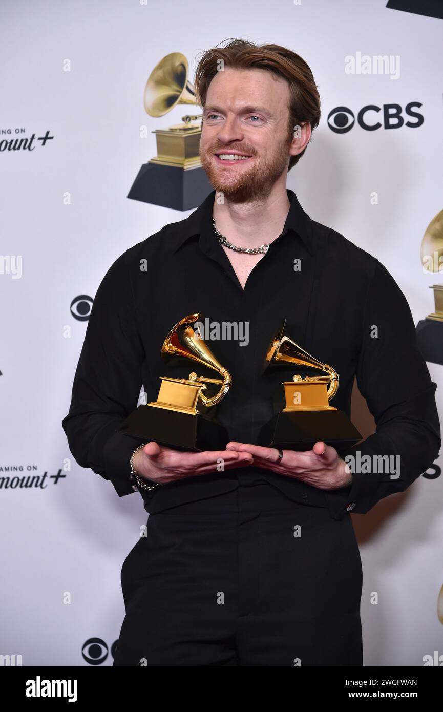 Finneas poses in the press room with the awards for best song written ...
