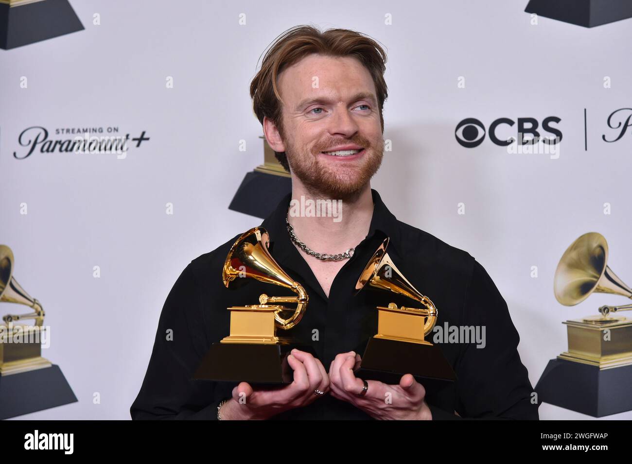Finneas poses in the press room with the awards for best song written ...