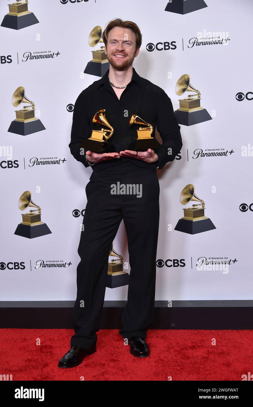 Finneas poses in the press room with the awards for best song written ...