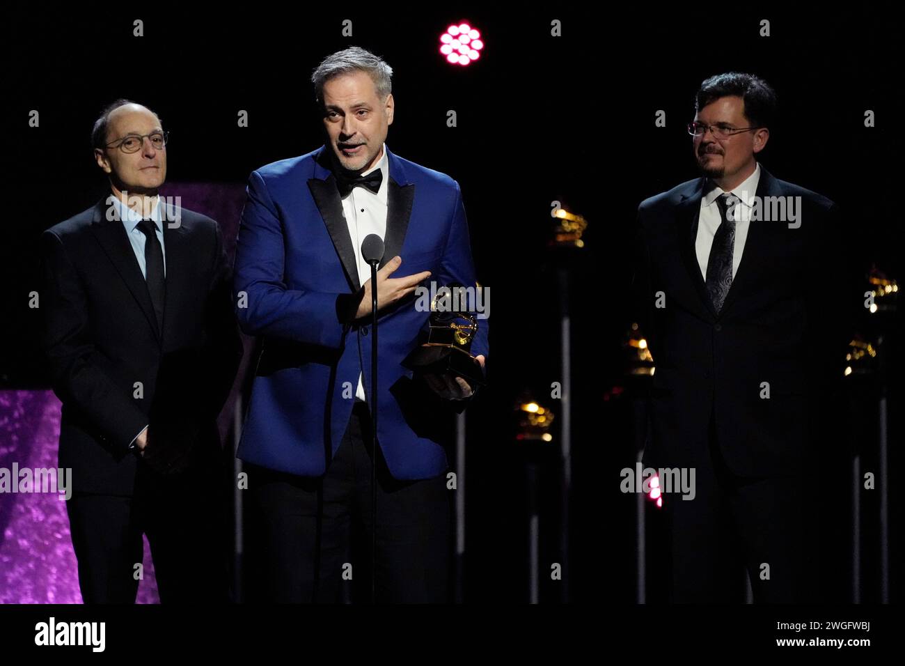 David Frost, from left, Charlie Post and Silas Brown accept the award ...