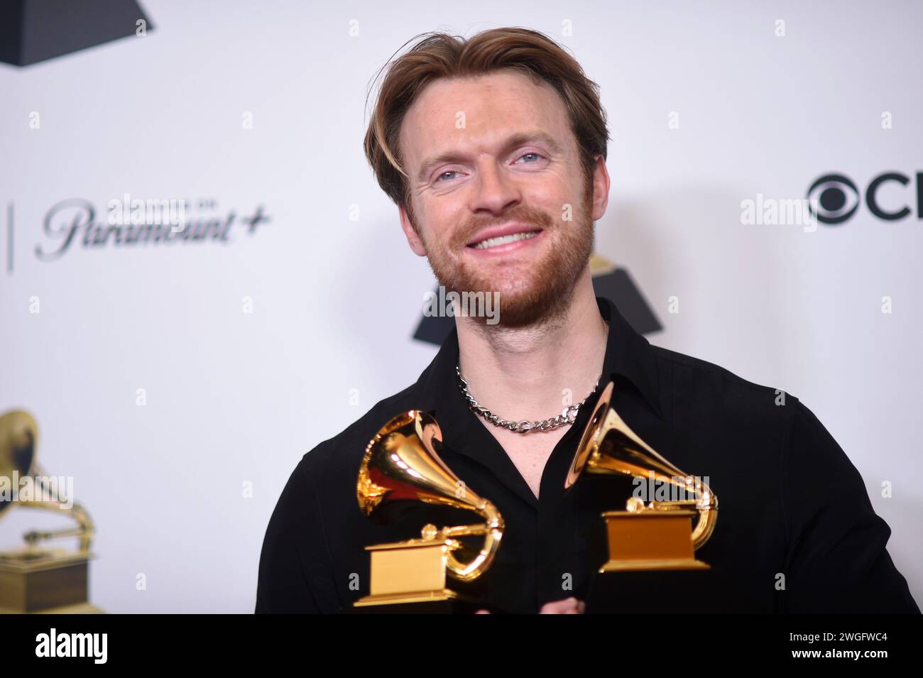 Finneas poses in the press room with the awards for best song written ...