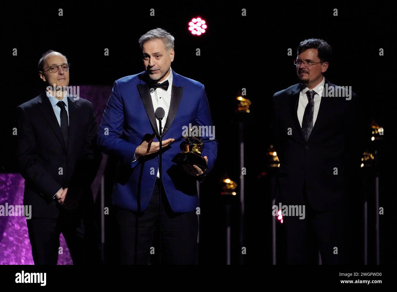 David Frost, from left, Charlie Post and Silas Brown accept the award ...