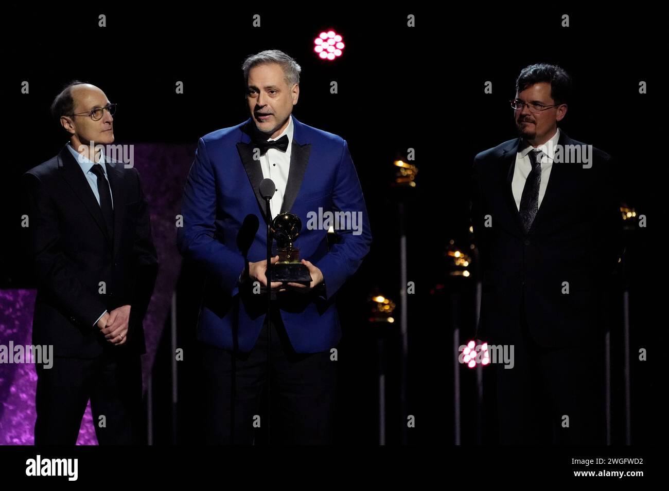 David Frost, from left, Charlie Post and Silas Brown accept the award ...
