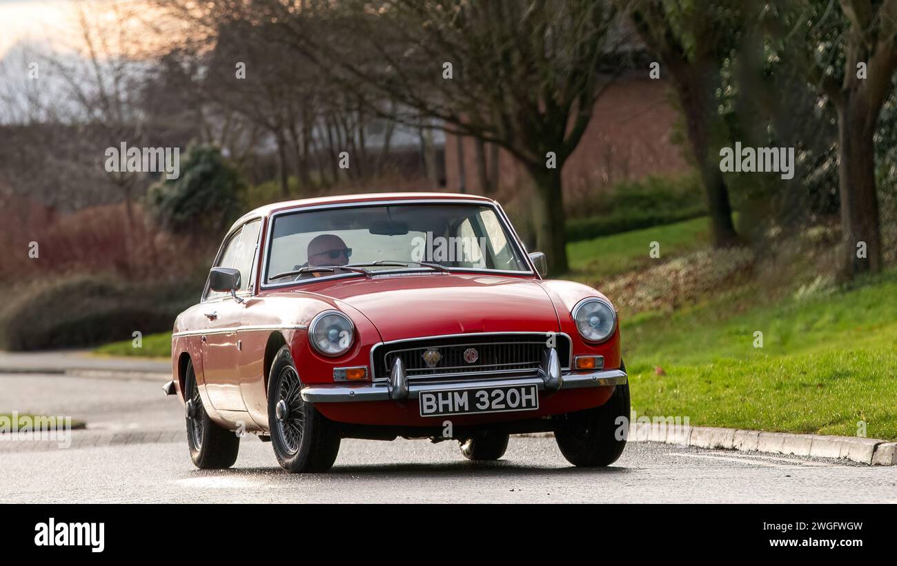 Milton Keynes,UK-Feb 4th 2024: 1970 red MGB GT classic car driving on ...