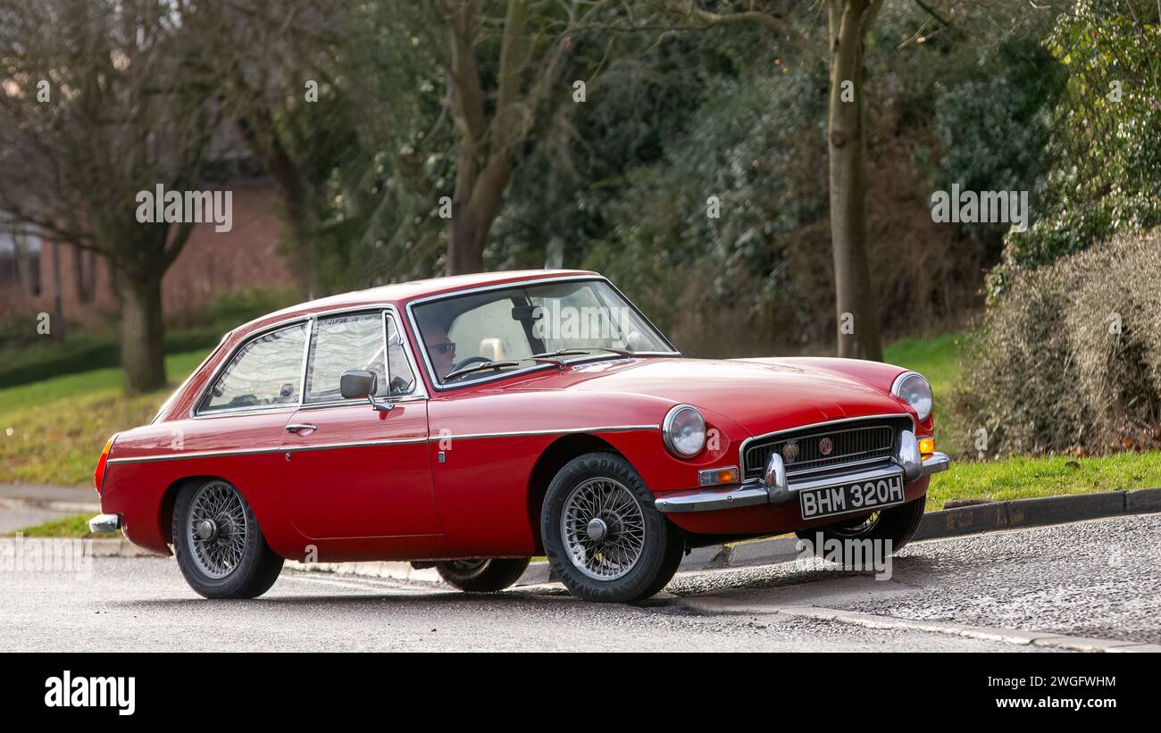 Milton Keynes,UK-Feb 4th 2024: 1970 red MGB GT classic car driving on ...