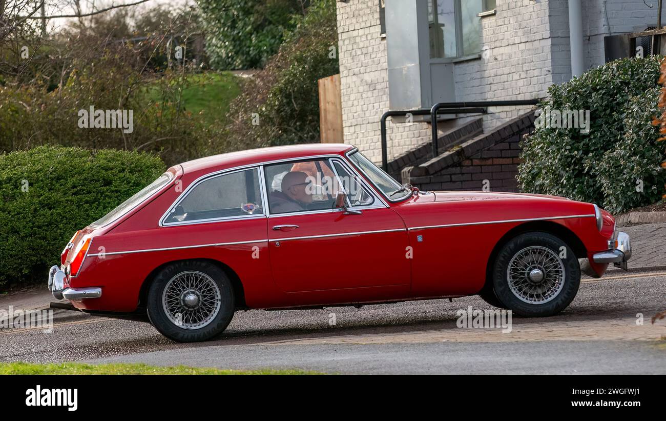Milton Keynes,UK-Feb 4th 2024: 1970 red MGB GT classic car driving on ...