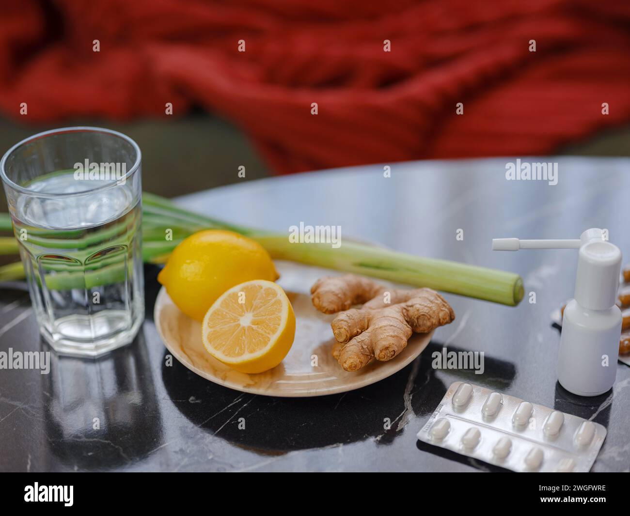 Ginger, lemon, onion and different drugs on table on background sick ...