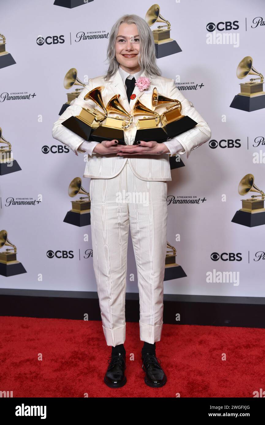 Phoebe Bridgers poses in the press room with the awards for best pop ...