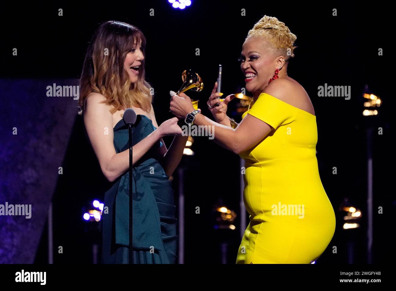 Molly Tuttle, left, presents Monica Ellis the award for best classical ...