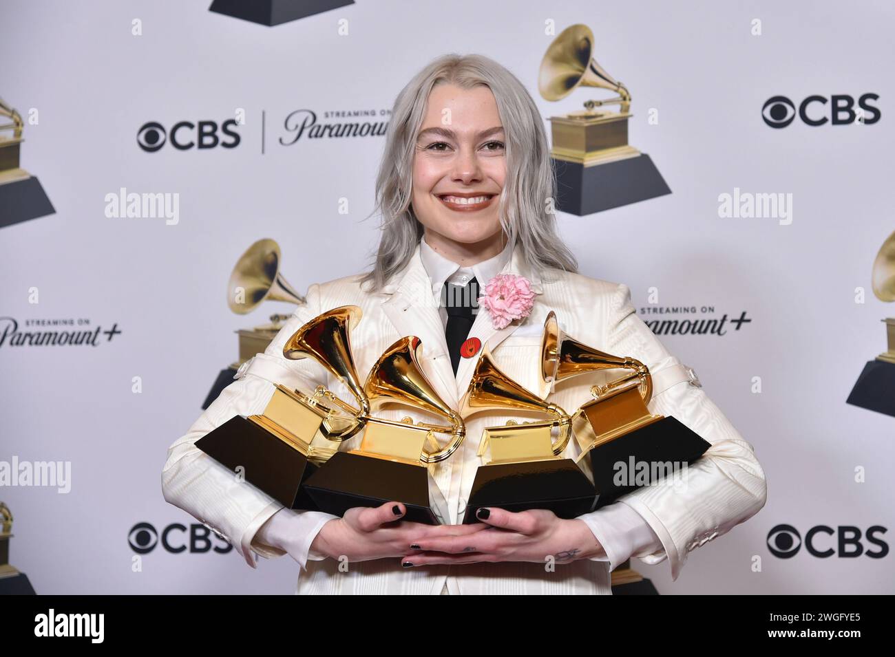 Phoebe Bridgers poses in the press room with the awards for best pop ...