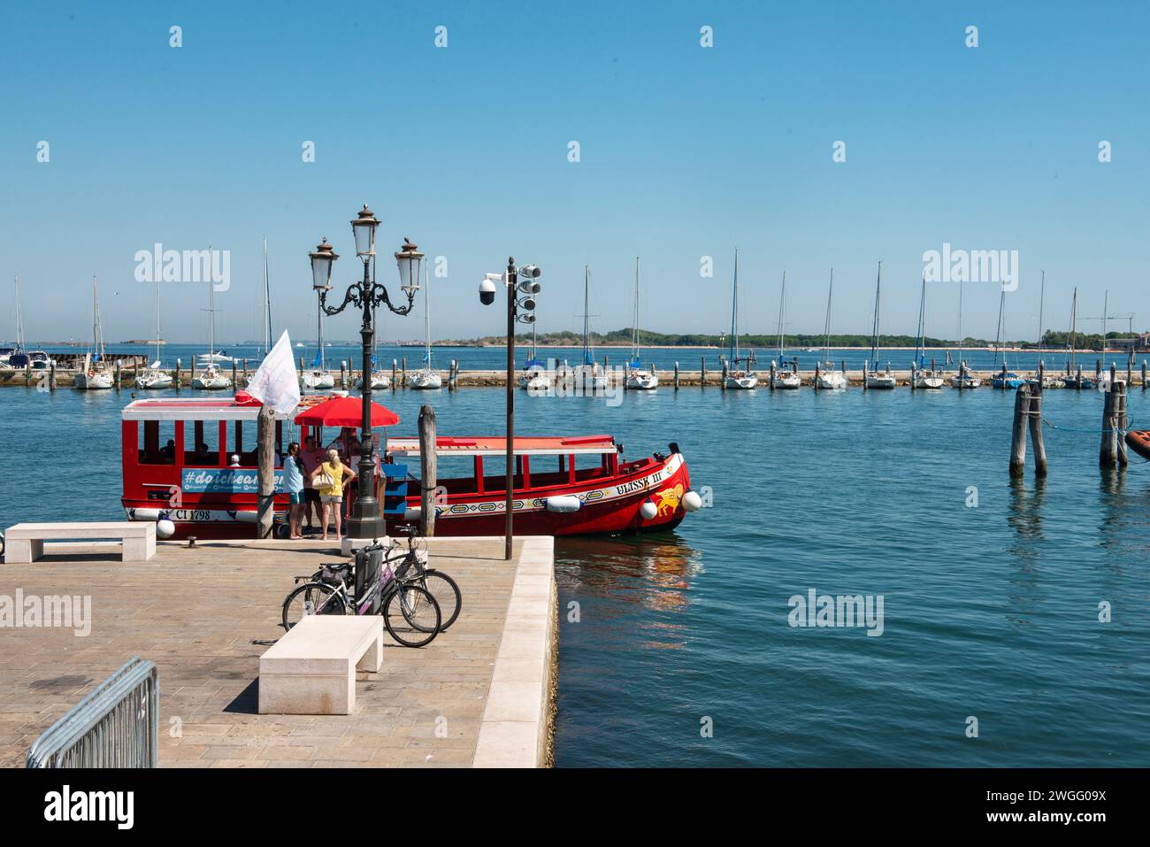 Tourists take a ride on a traditional boat called a Bragozzo, this one ...