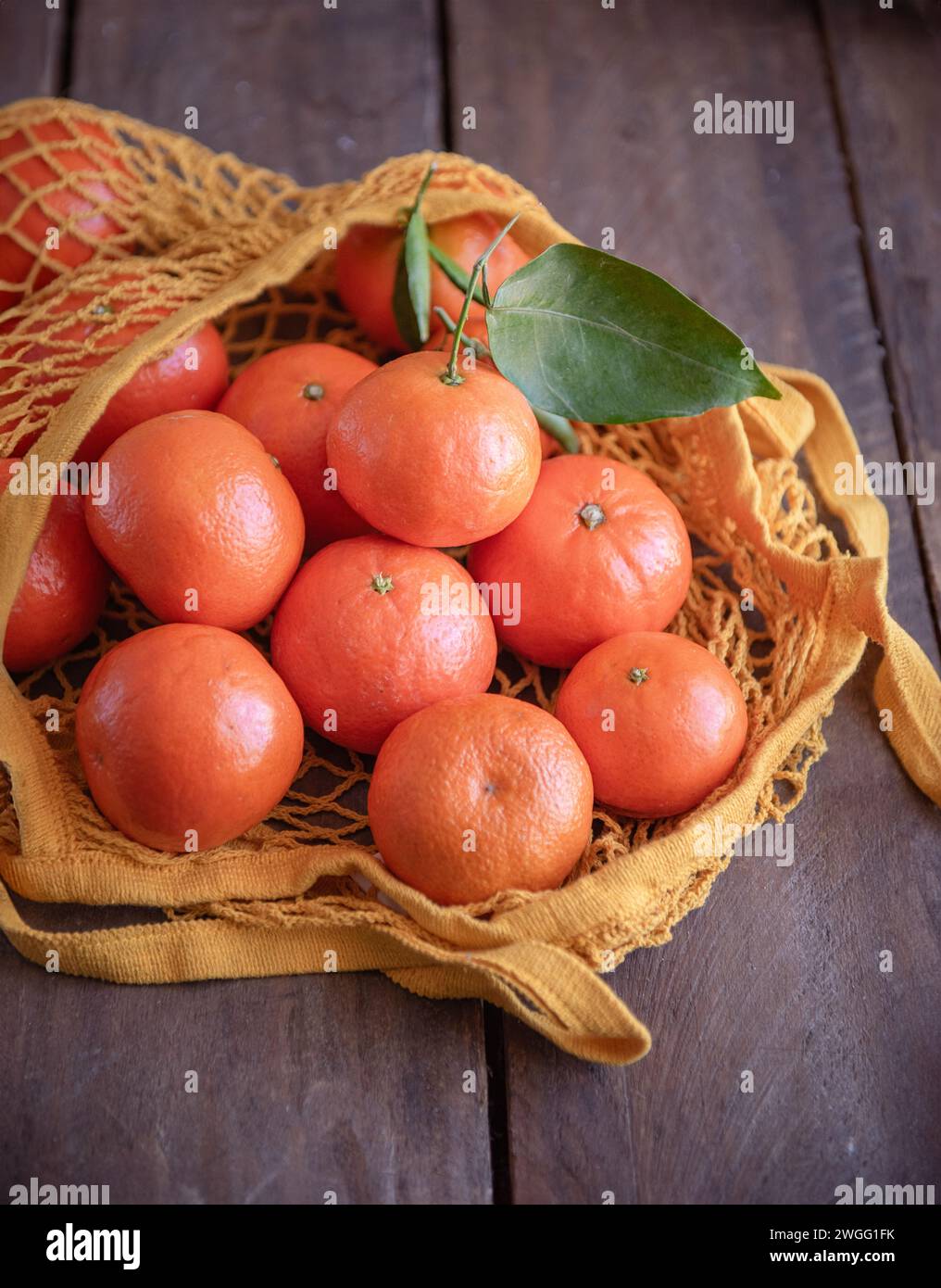Several mandarins in net. Isolated on white background Stock Photo - Alamy