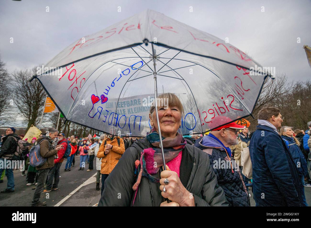 Extinction Rebellion female activist under a large transparent umbrella ...