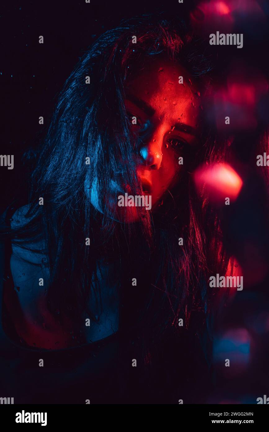 Sensual portrait of sad melancholic lonely girl behind glass with ...