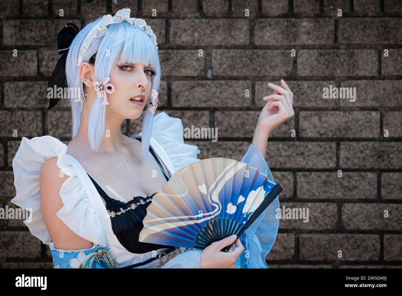 A female cosplayer in a vintage blue dress with blue hair Stock Photo ...