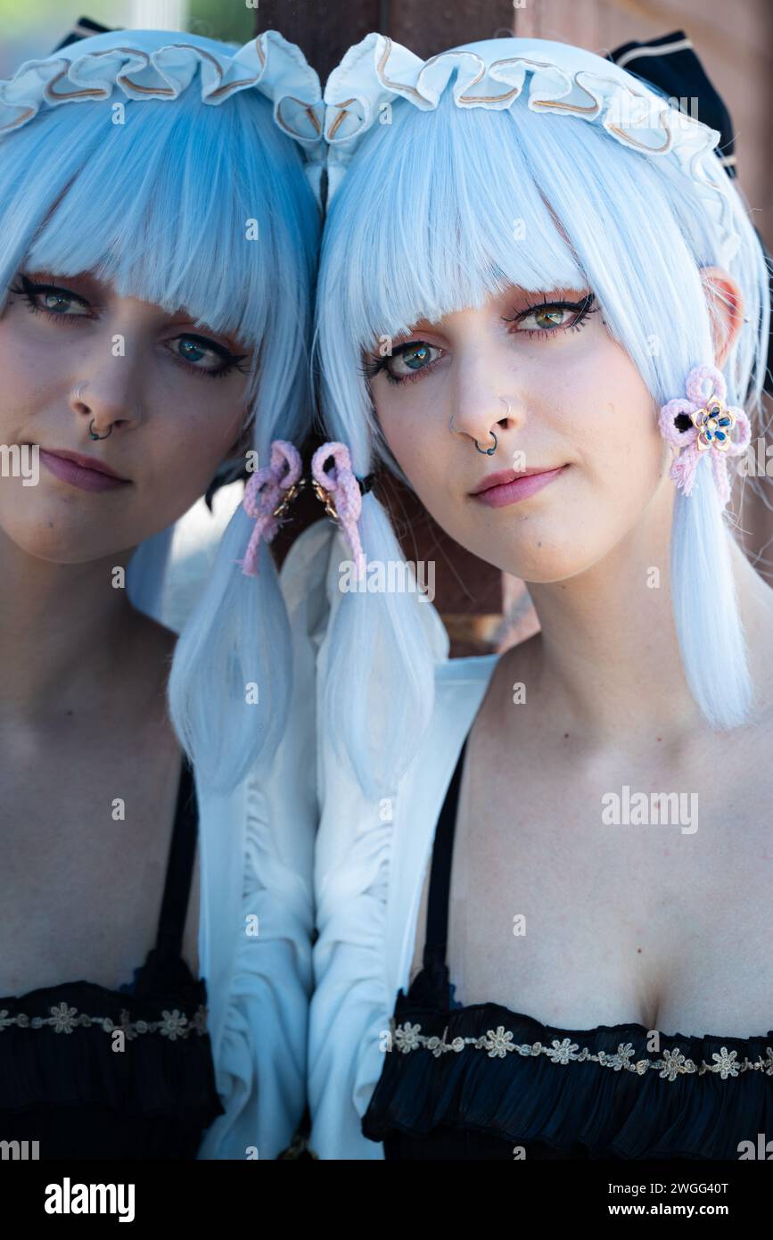 A female cosplayer in a vintage blue dress with blue hair Stock Photo ...