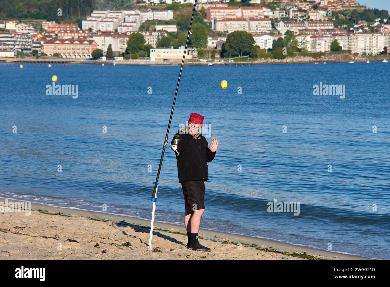 Baiona, Spain; July,14,2021: Angler with a red hat and his rod stuck in ...