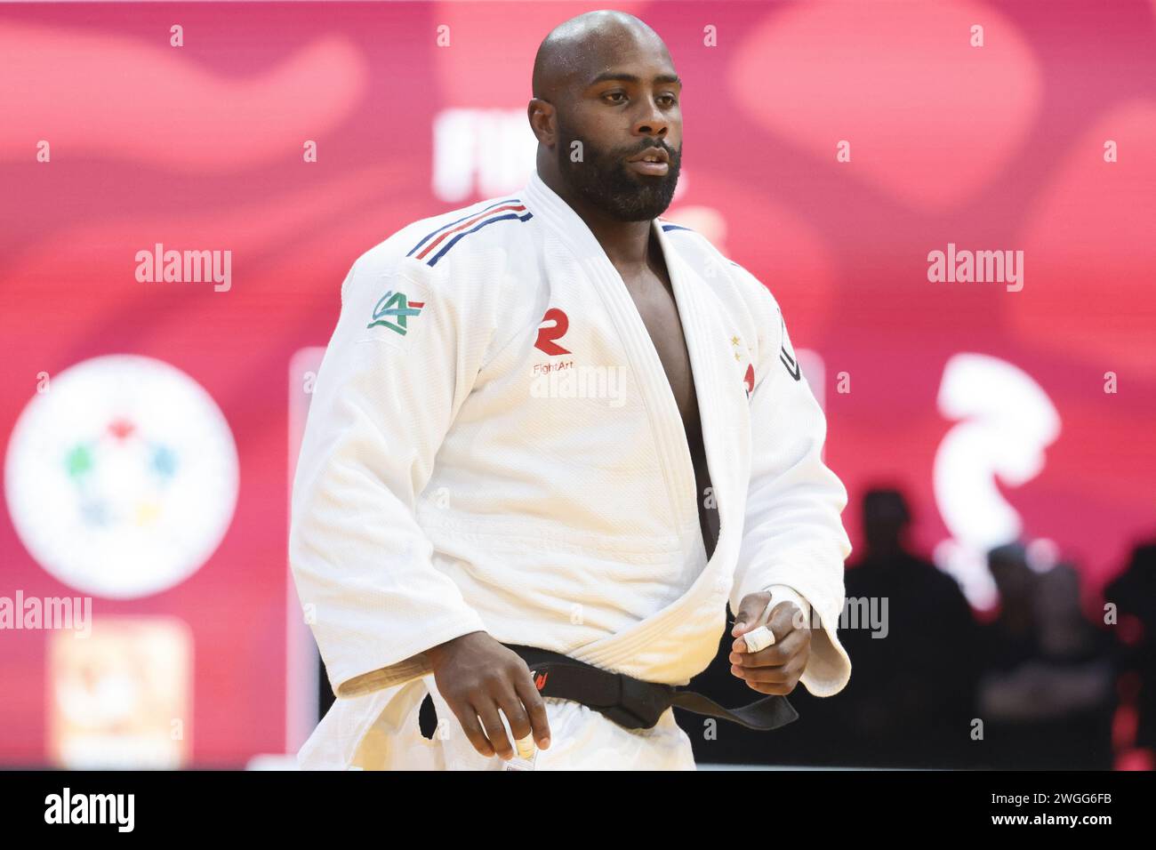 Teddy Riner of France (white) fights against Minjong Kim of South Korea ...