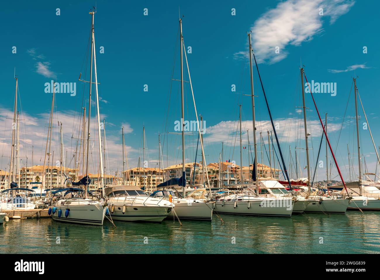 Yachts under blue sky moored on marina in Frejus - city and popular ...