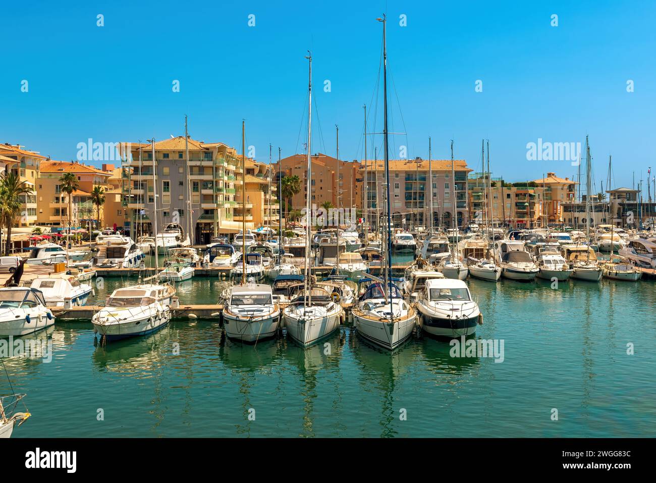 Yachts and boats under blue sky moored on marina in Frejus - city and ...